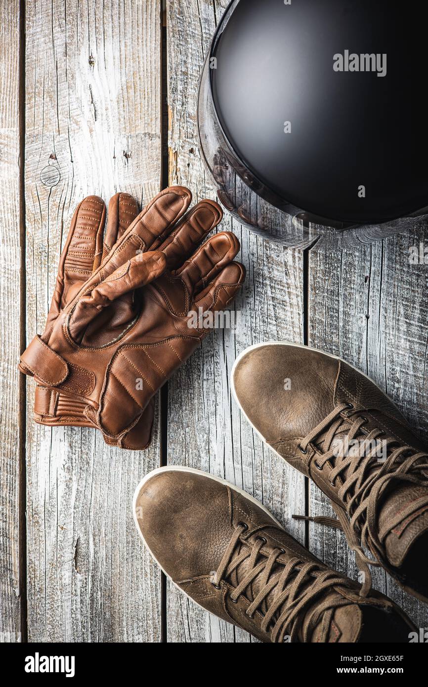 Safety motorcycle accessories. Leather gloves, helmet and shoes on ...