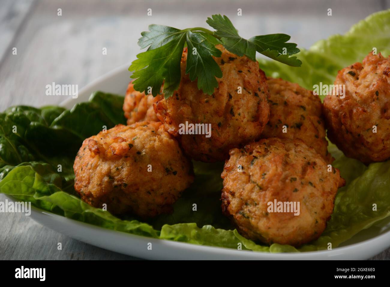 Fried fish meatballs with parsley Stock Photo - Alamy