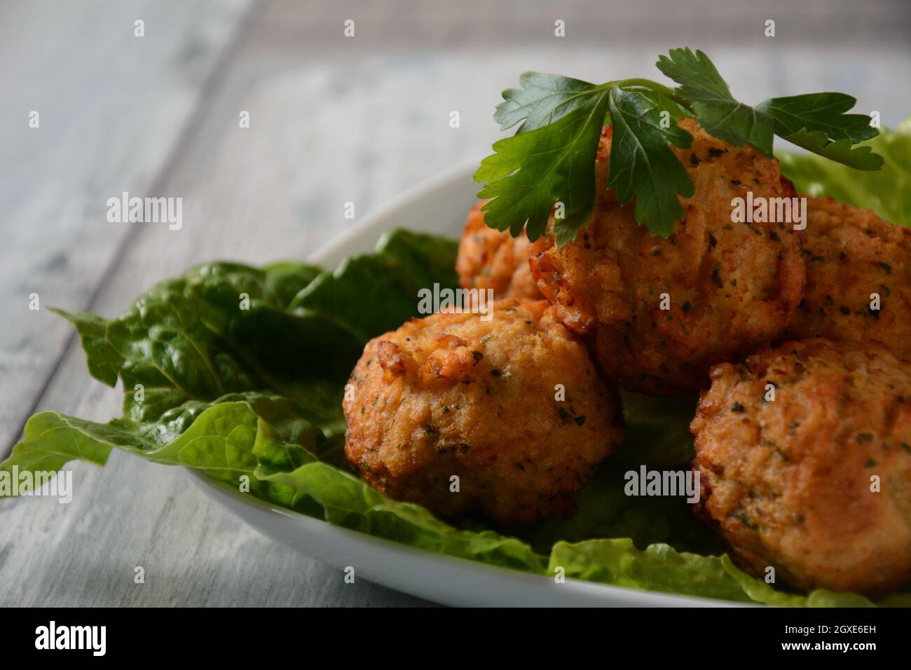 Fried fish meatballs with parsley Stock Photo - Alamy