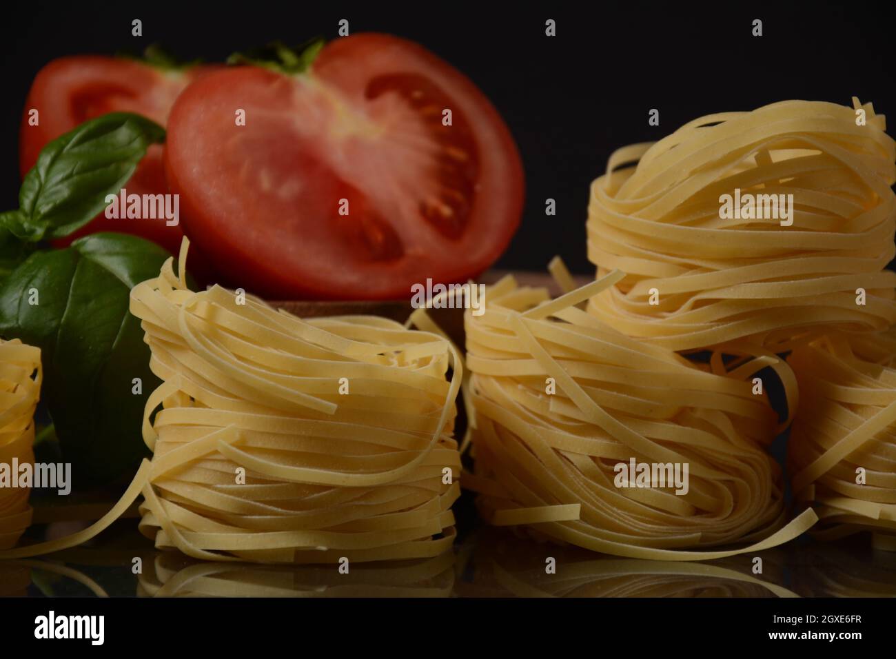Uncooked tagliatelle. Italian food ingredients for pasta Stock Photo ...