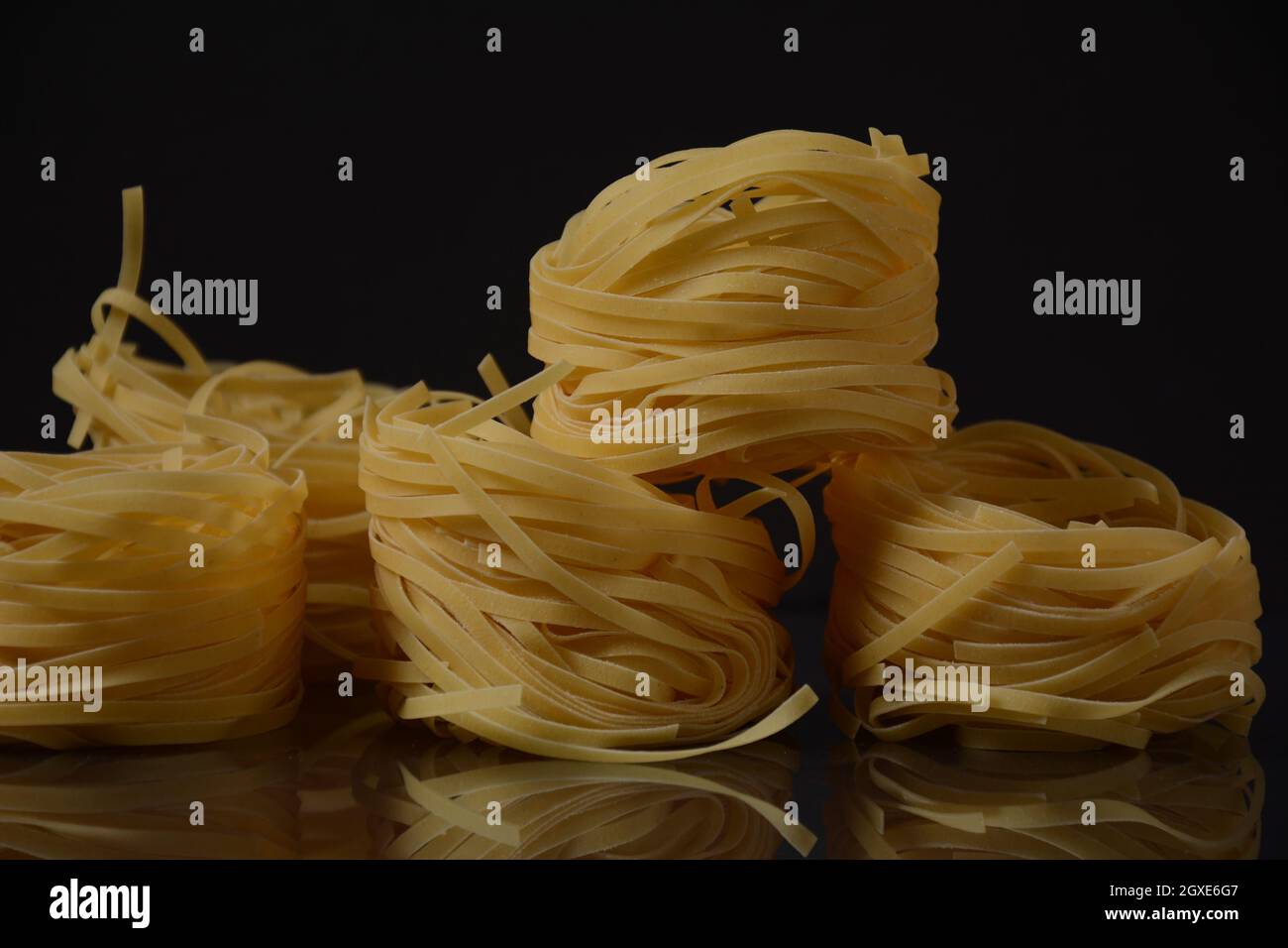 Uncooked tagliatelle. Italian food ingredients for pasta Stock Photo ...