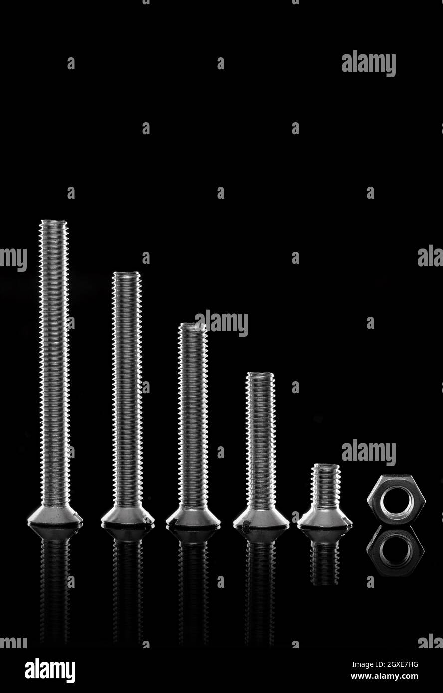 Chrome screws and bolt on black background Stock Photo - Alamy