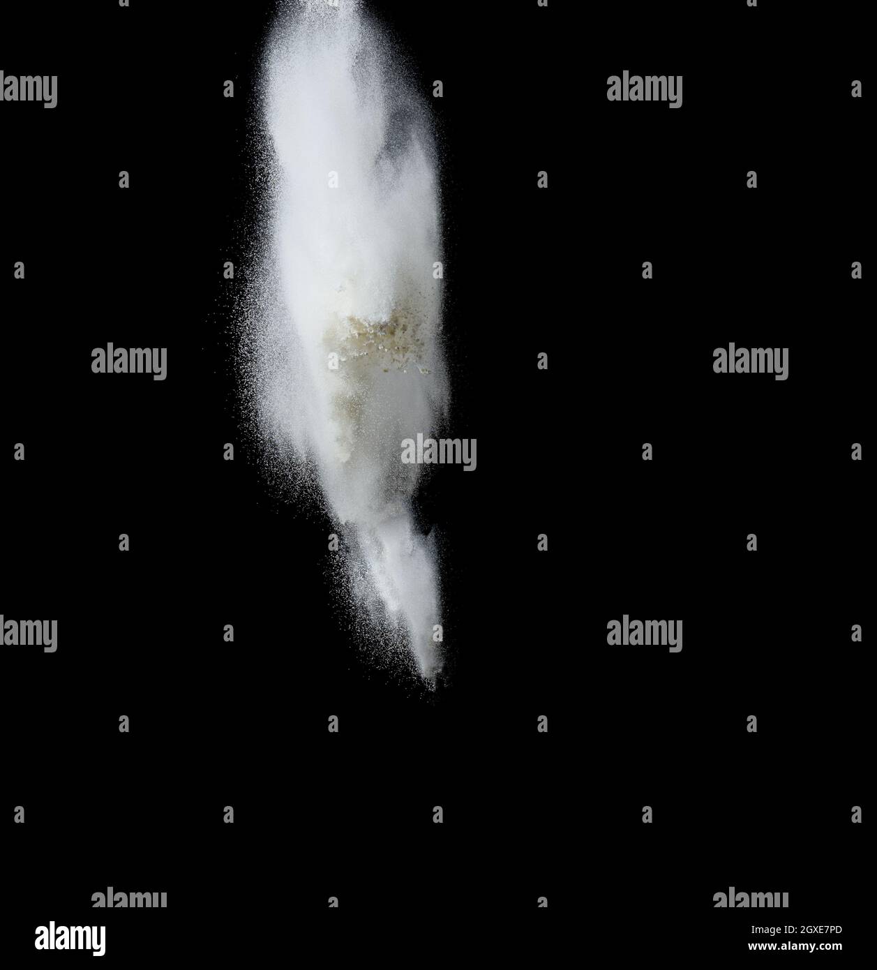 cloud of white wheat flour on a black background, particles fly in ...