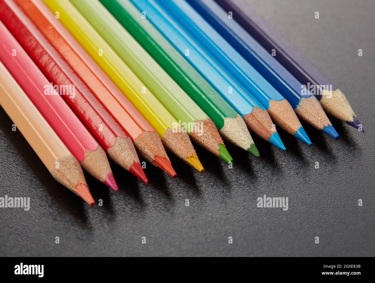Multi-colored pencils on black background Stock Photo - Alamy