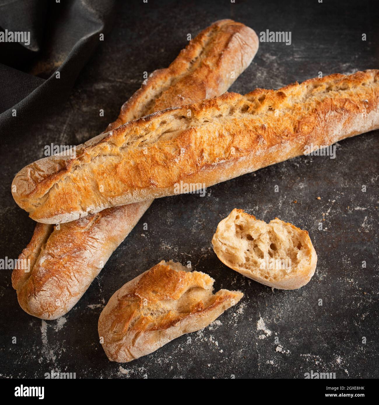 Fresh crispy french baguette on black background. Atmosphäric food ...