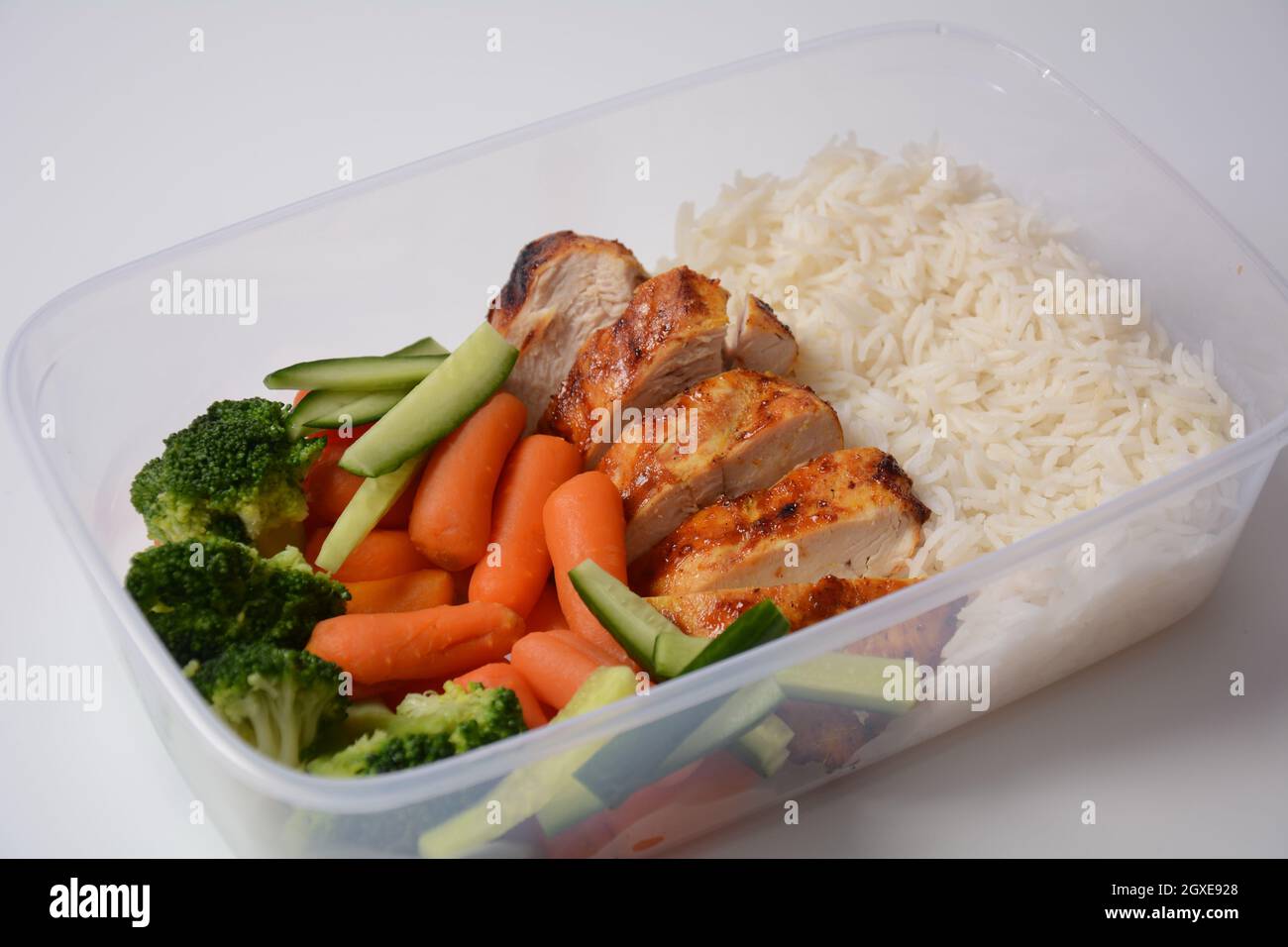 Healthy balanced lunch boxes. Grilled chicken, carrots, cucumbers ...