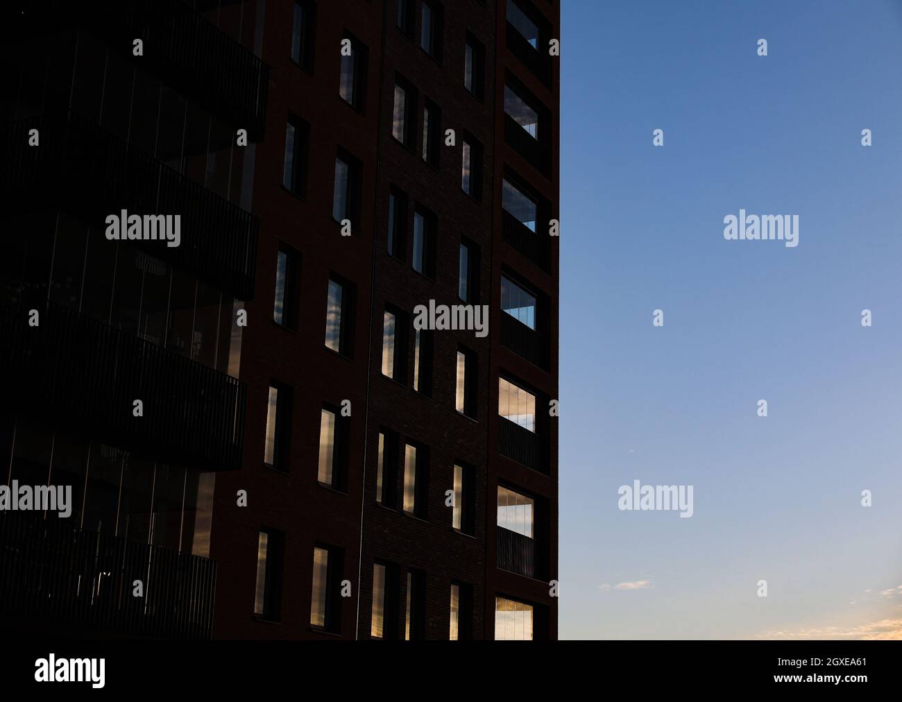 Modern building exterior reflecting the sunset in the windows Stock ...