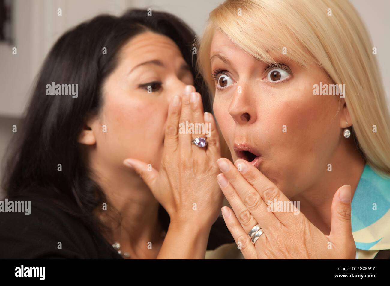 Two Friends Whispering Secrets in the Ear Stock Photo - Alamy
