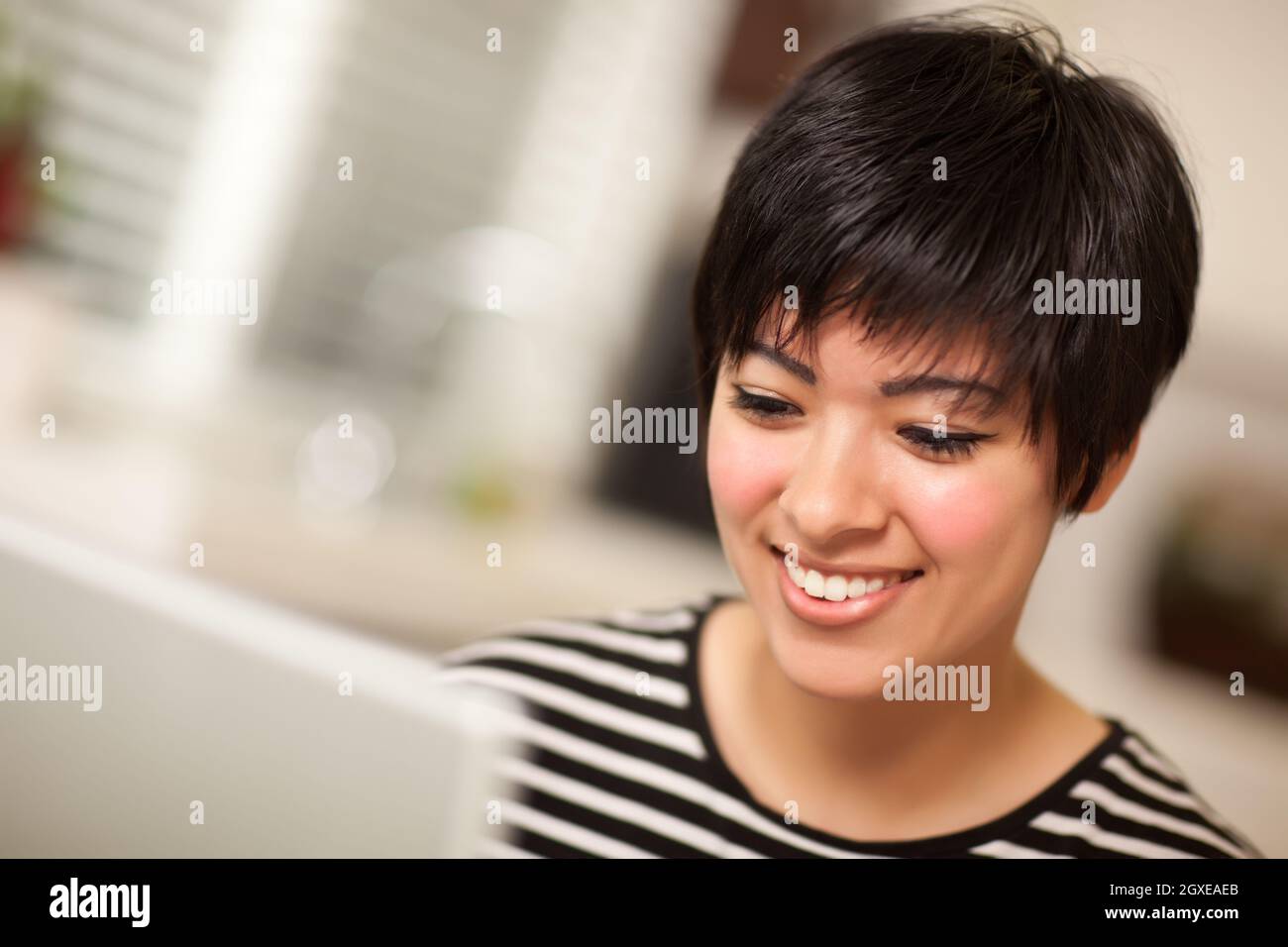 Pretty Smiling Multiethnic Woman Using Her Laptop Computer Stock Photo ...