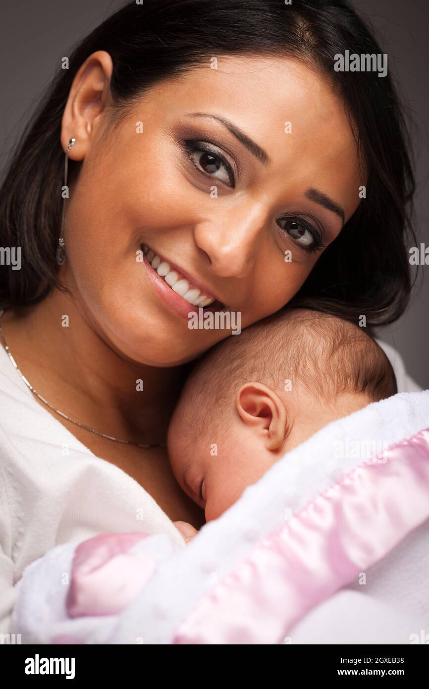 Young Attractive Ethnic Woman Holding Her Newborn Baby Under Dramatic ...