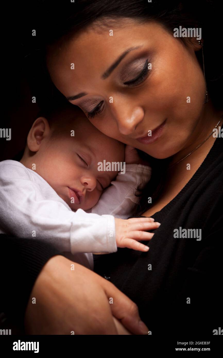 Young Attractive Ethnic Woman Holding Her Newborn Baby Under Dramatic ...