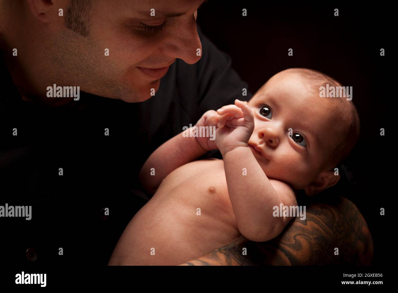 Happy Young Father Holding His Mixed Race Newborn Baby Under Dramatic ...