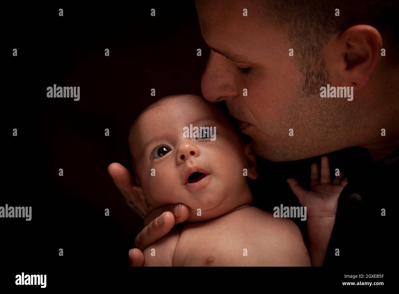 Happy Young Father Holding His Mixed Race Newborn Baby Under Dramatic ...