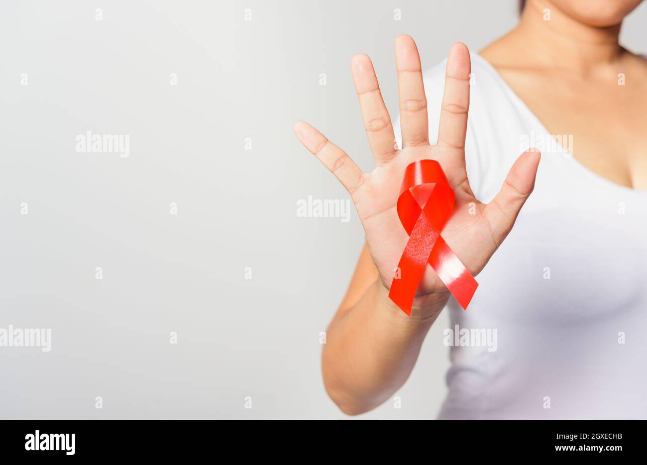 Closeup of female with red ribbon Support HIV AIDS on hand, World AIDS ...
