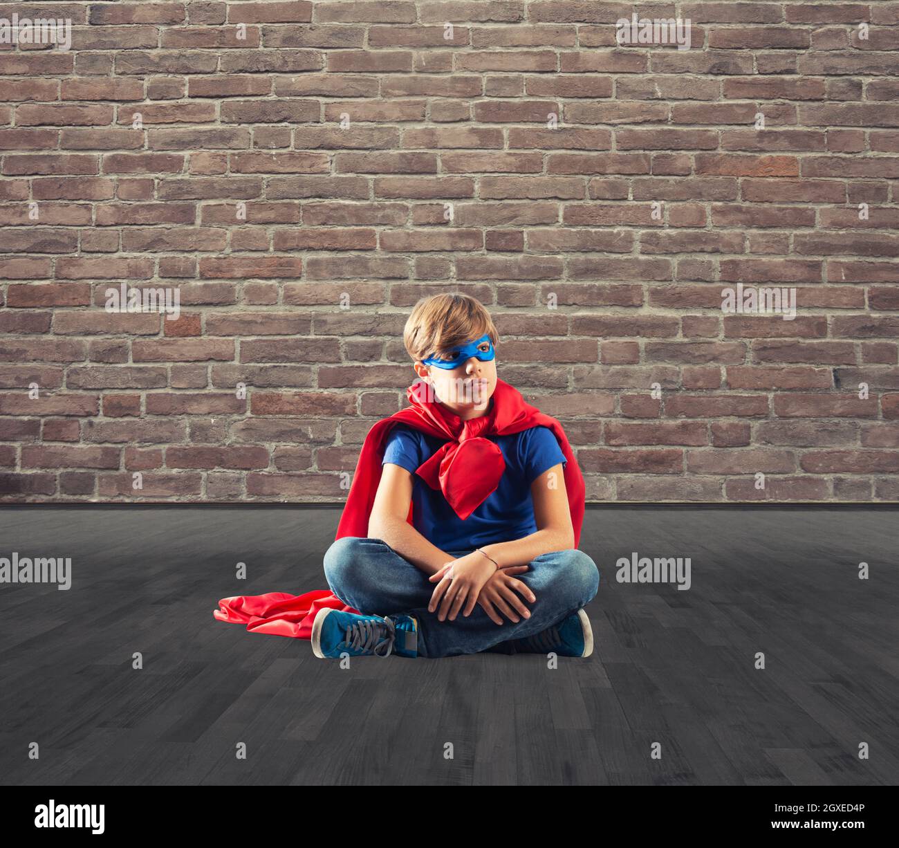 Superhero kid sitting on a wall that dreams something Stock Photo - Alamy