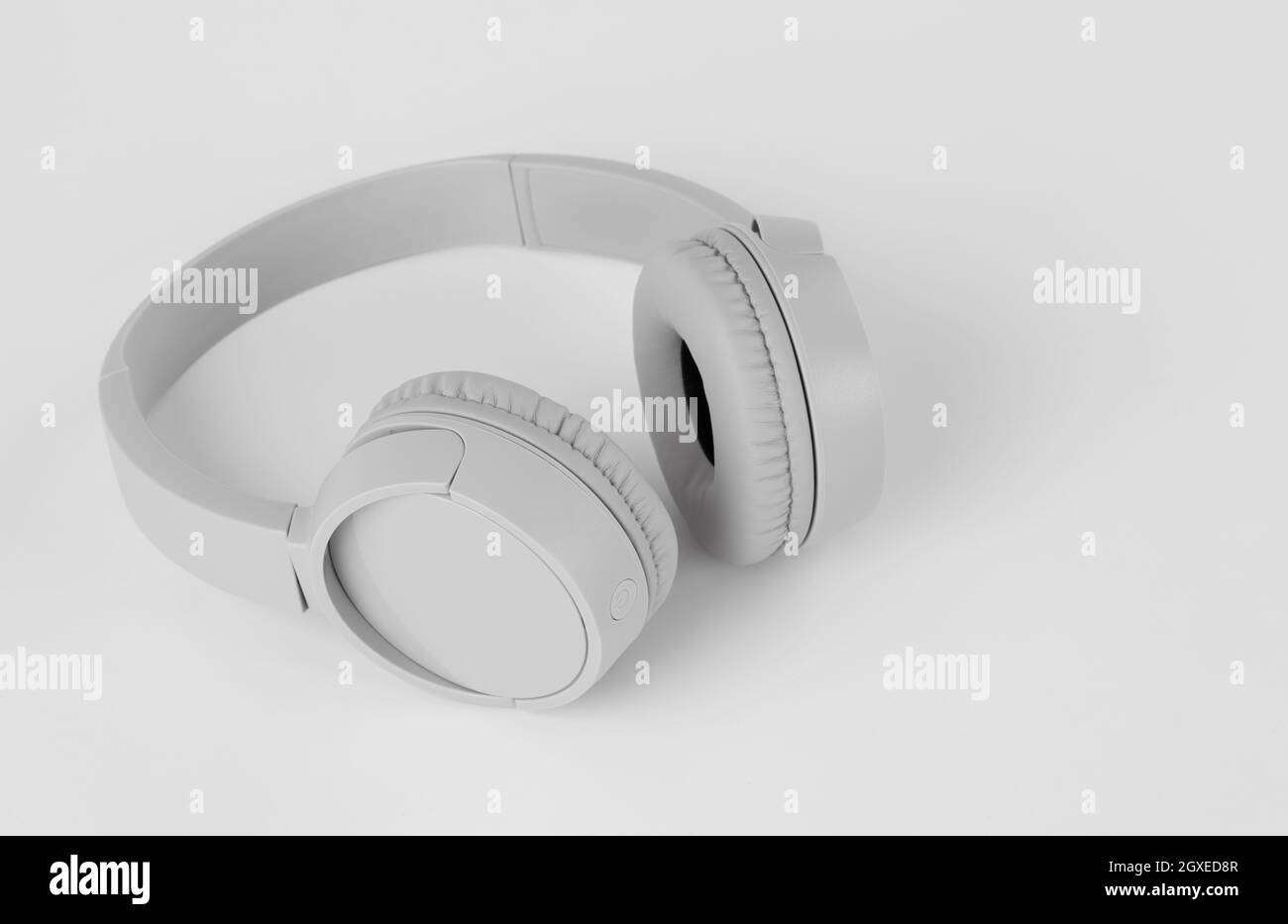 Wireless gray headphones on gray background Stock Photo - Alamy