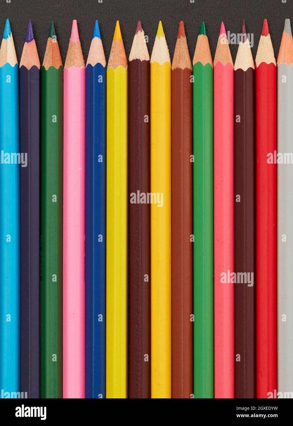 Multi-colored pencils on black background Stock Photo - Alamy