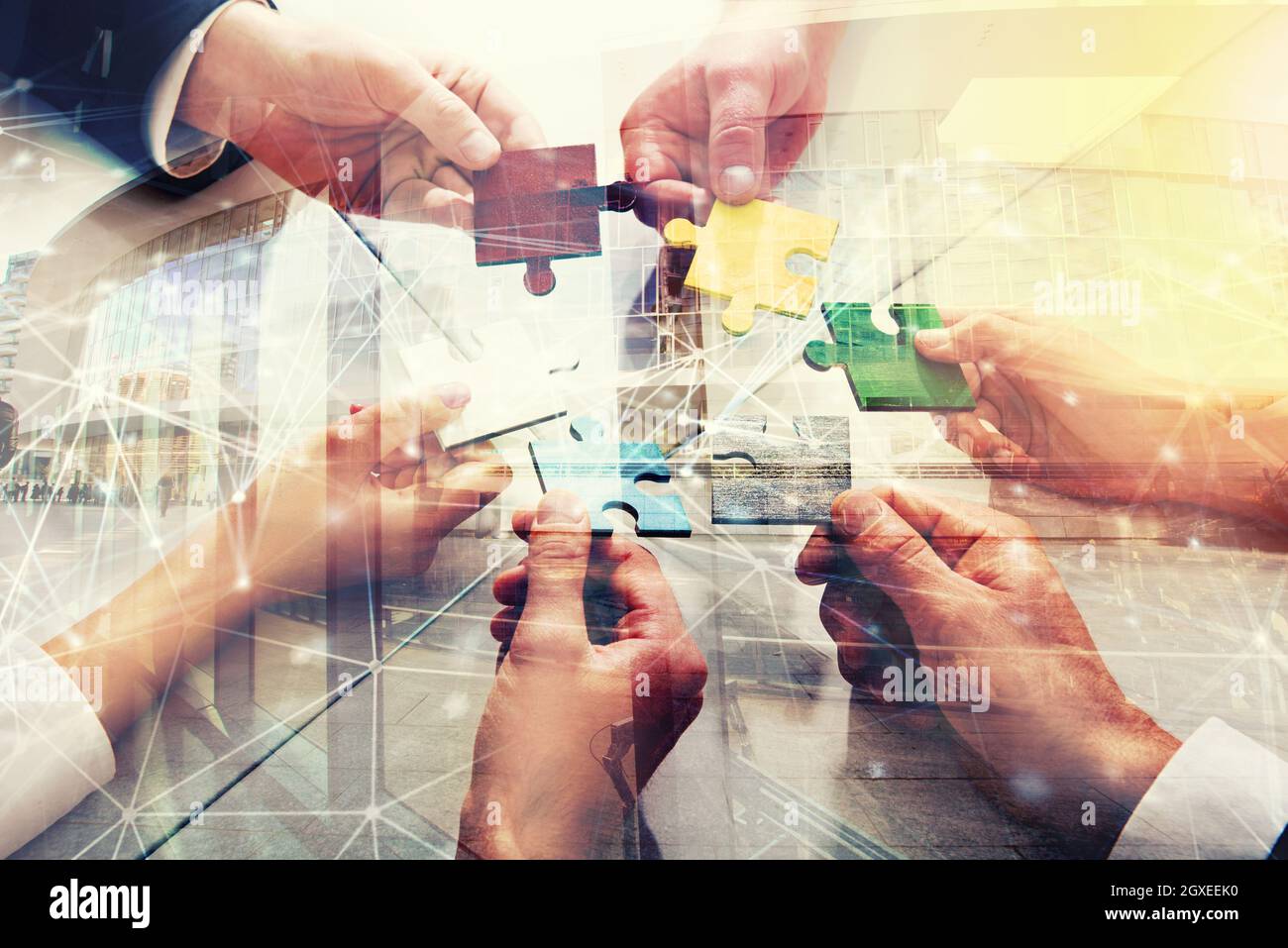 Businessmen working together to build a colored puzzle. Concept of ...