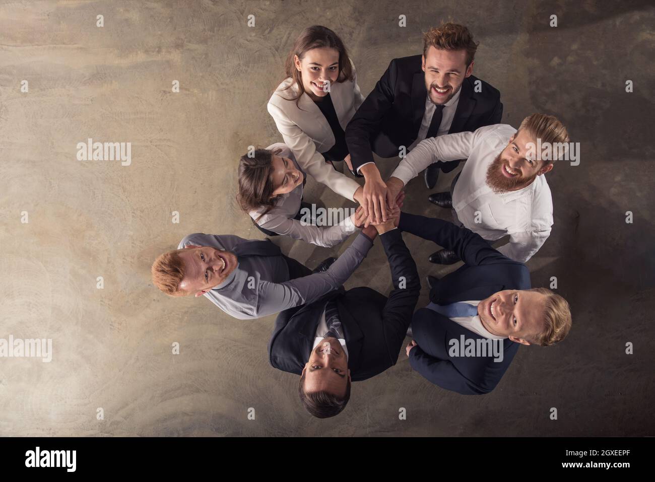 Business people putting their hands together in office. Concept of ...