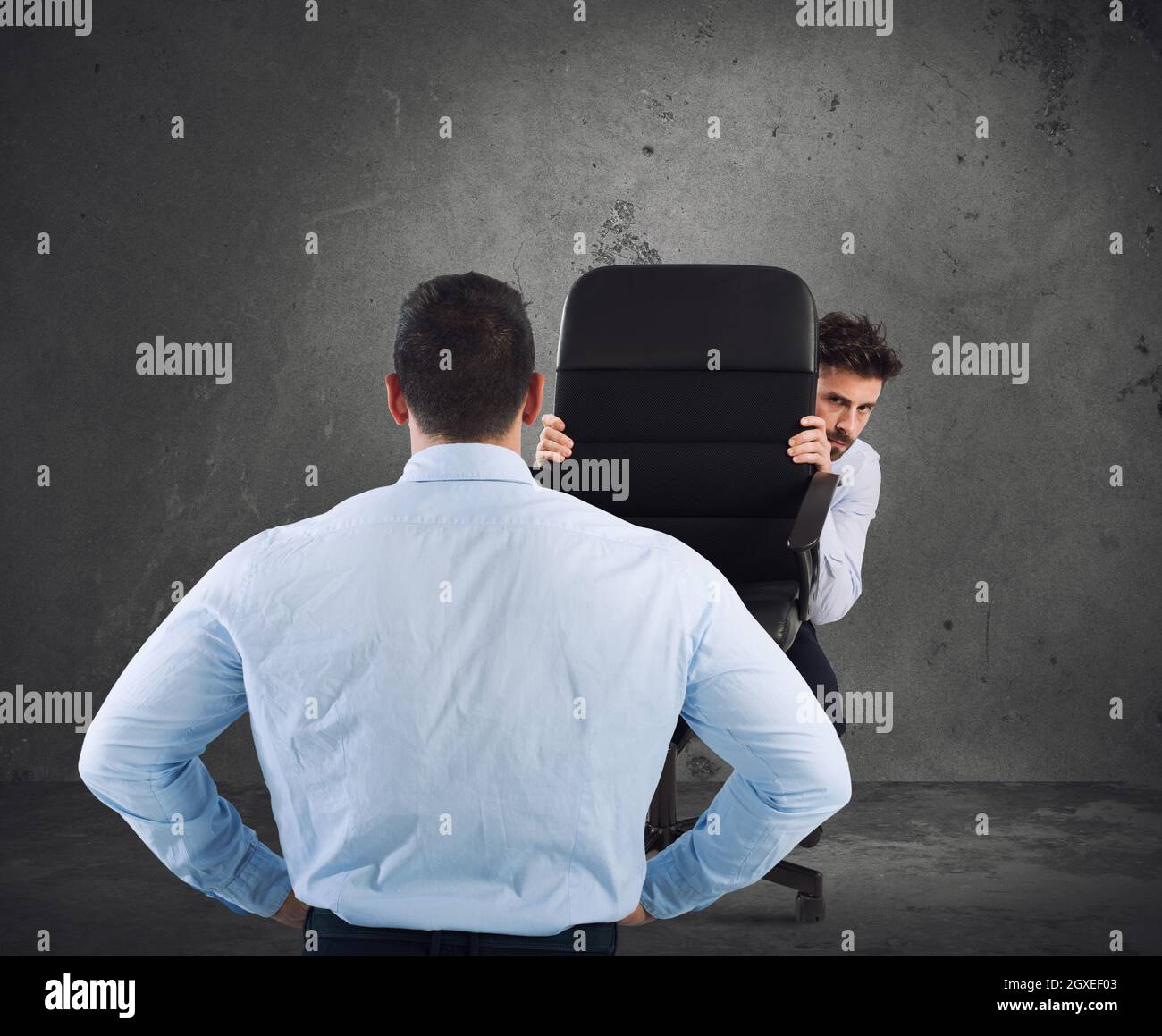 Employee hiding behind chair is afraid of his boss Stock Photo - Alamy