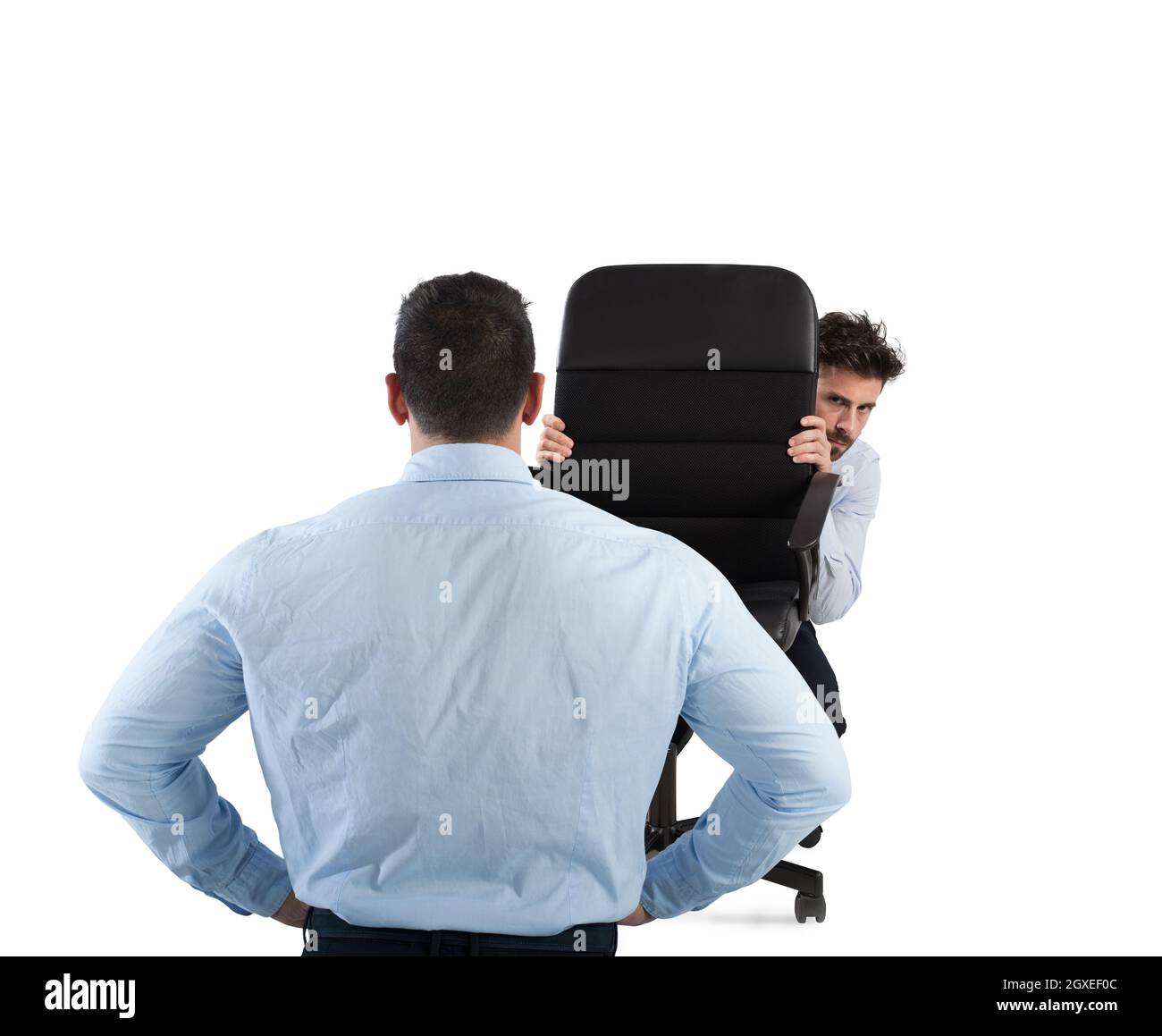 Employee hiding behind chair is afraid of his boss Stock Photo - Alamy