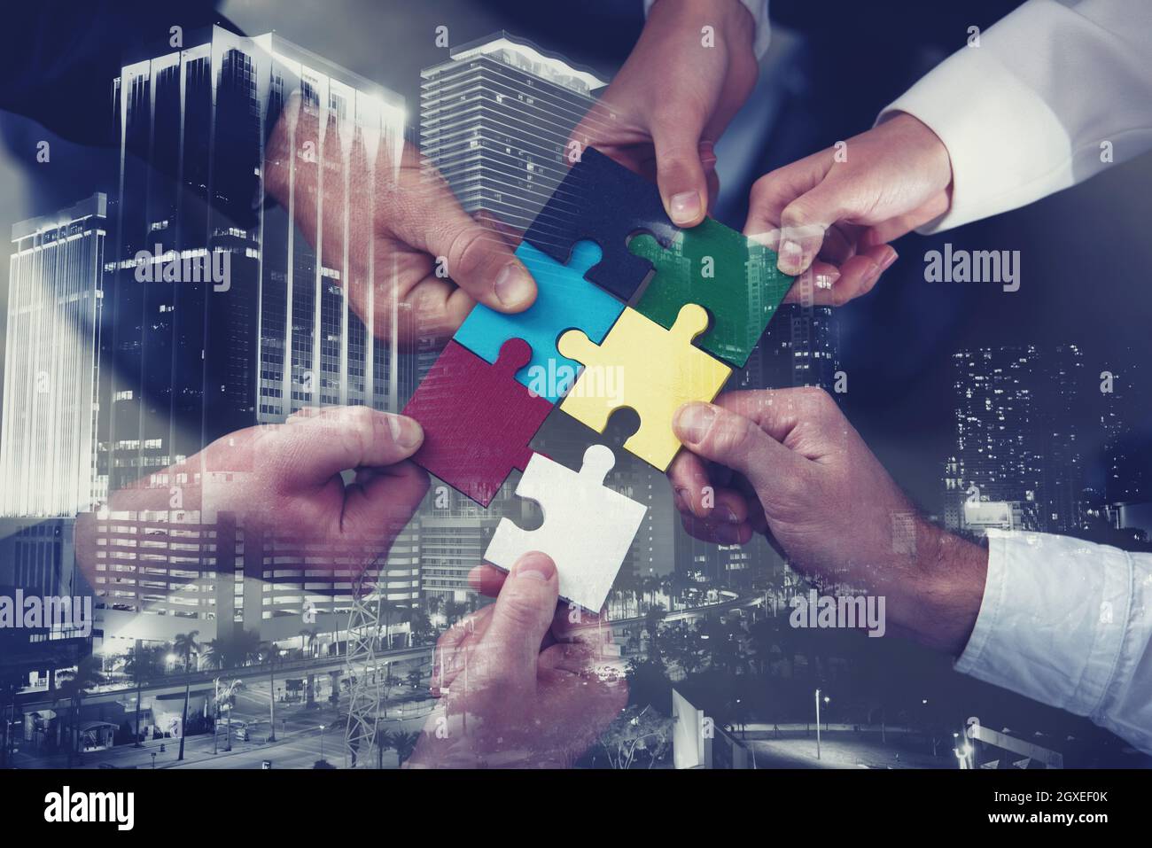 Businessmen working together to build a colored puzzle. Concept of ...