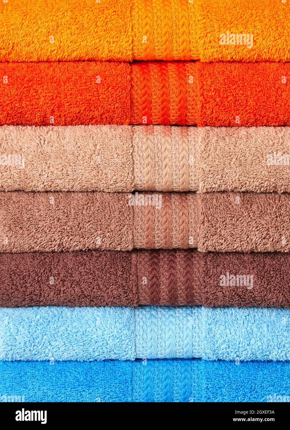 Folded stack of towels on white background Stock Photo - Alamy