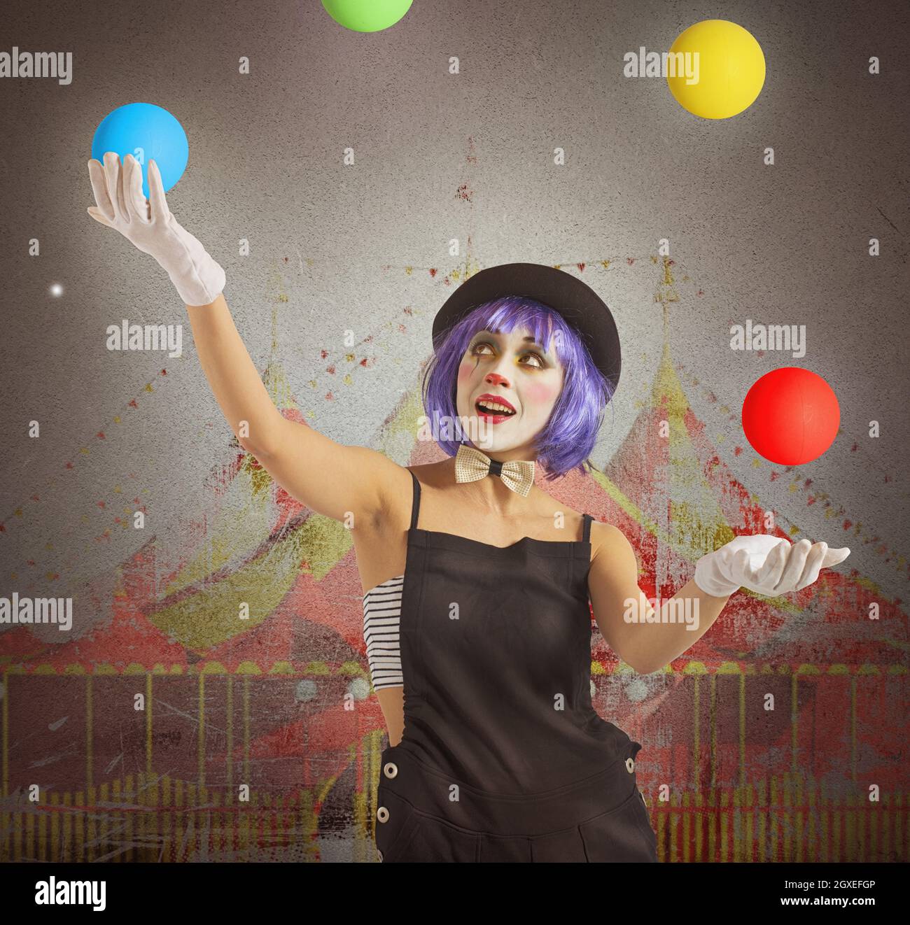 Concentrated juggler clown playing with colorful ball Stock Photo - Alamy