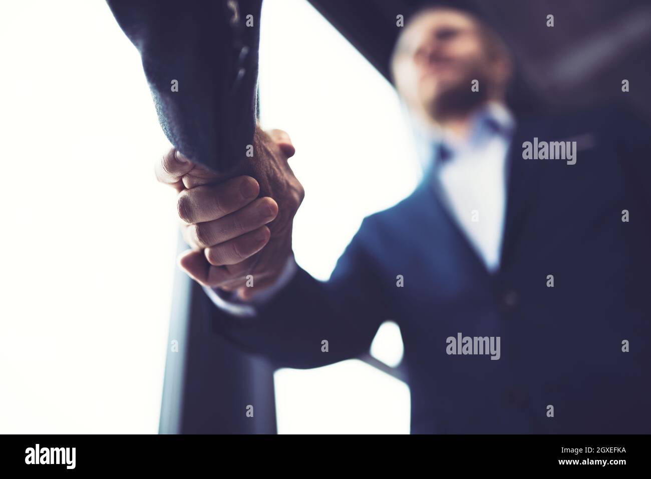 Handshaking business person in the office with network effect. concept ...