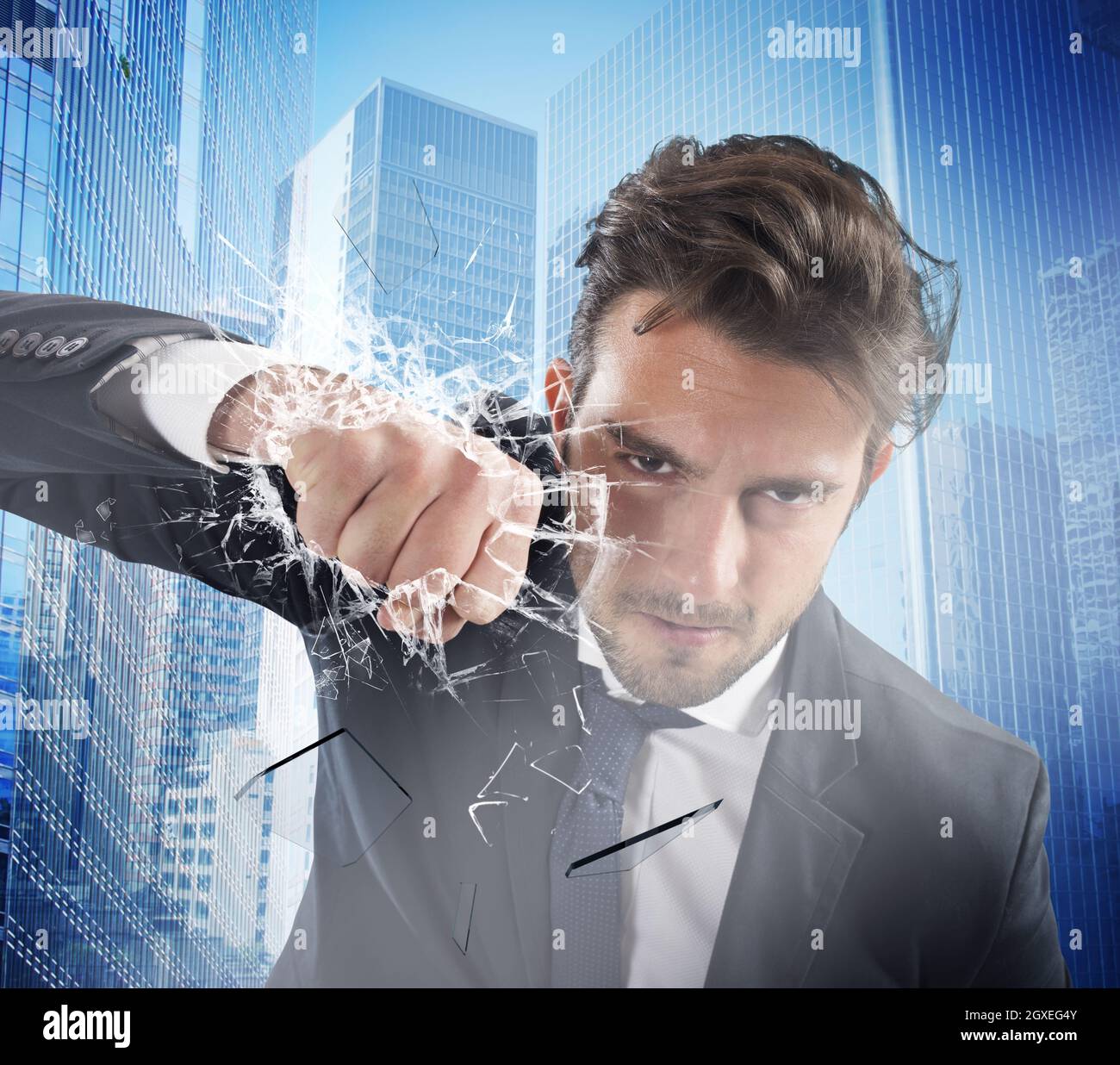Determined businessman breaks the glass with punch Stock Photo - Alamy