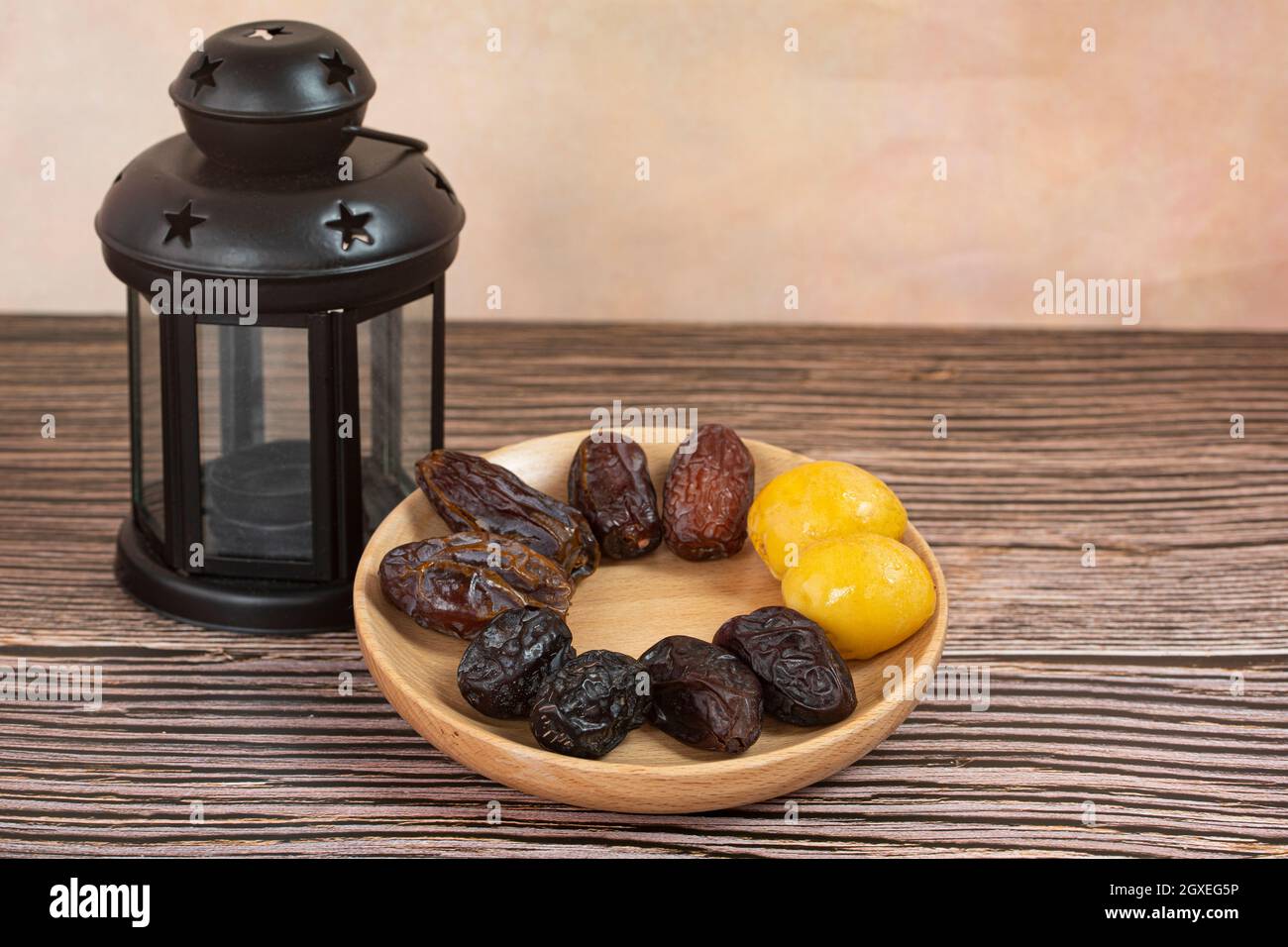 Bunch of different types of dates in a circle in a plate with lantern ...