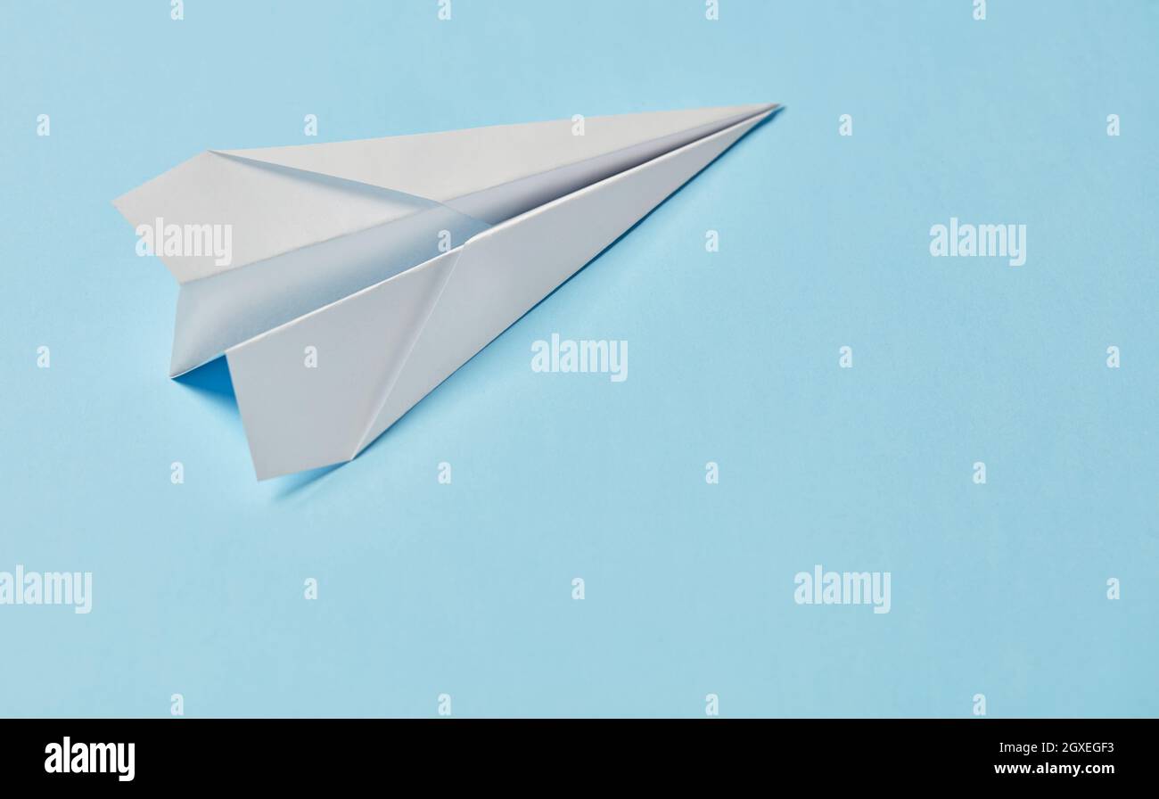 Paper airplane on blue background Stock Photo - Alamy