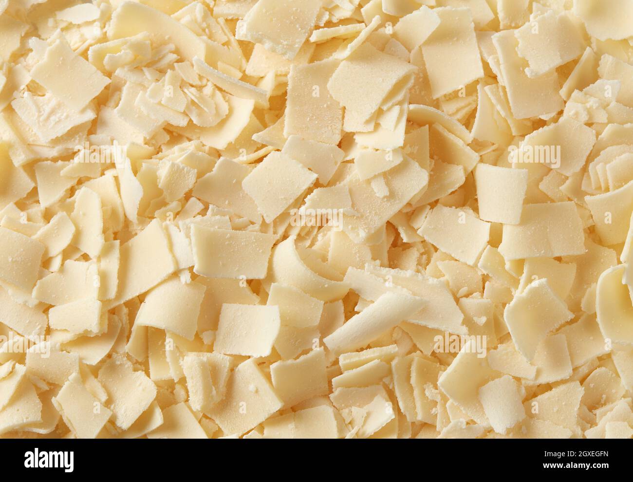 Parmesan flakes background Stock Photo - Alamy