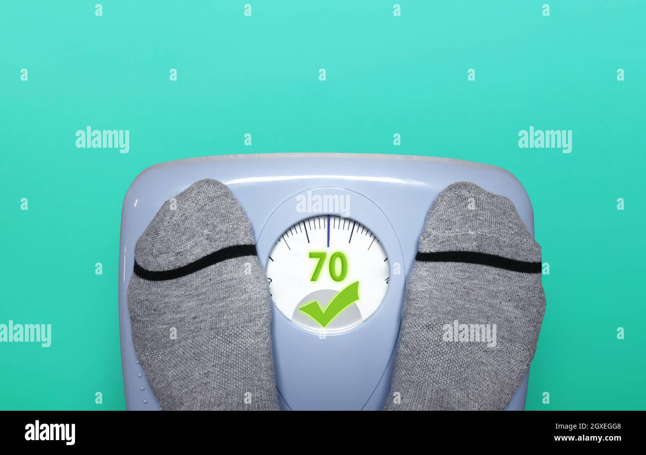 Person check his weight with a balance Stock Photo - Alamy