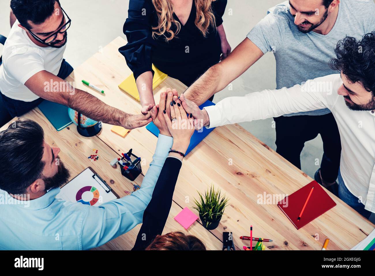 Business people putting their hands together in office. Concept of ...