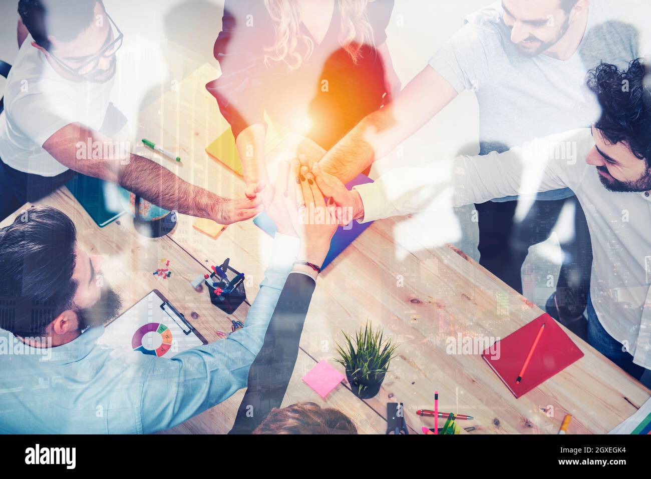 Business people putting their hands together in office. Concept of ...