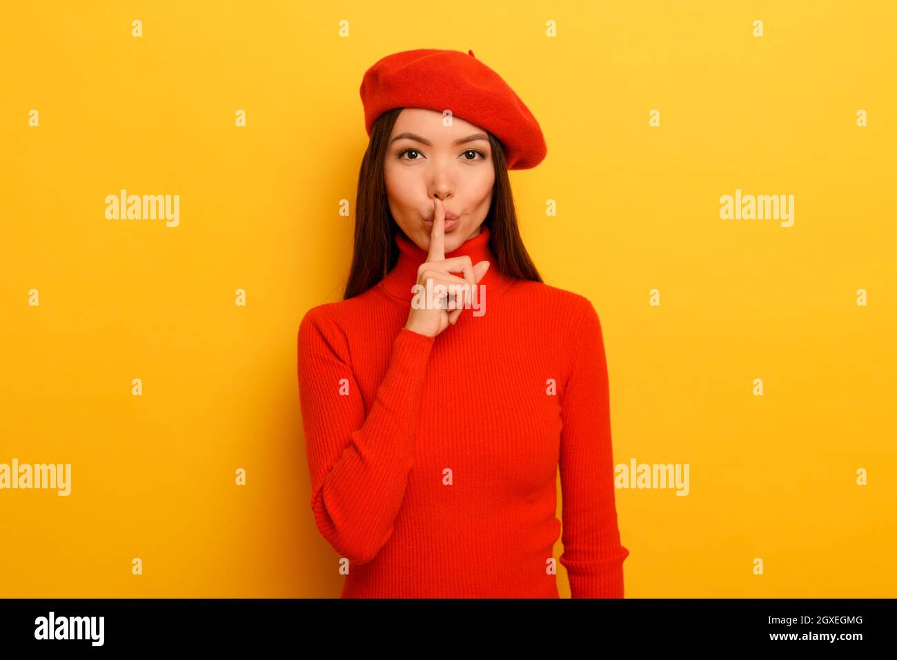 Woman indicates with the hand to be quite Stock Photo - Alamy