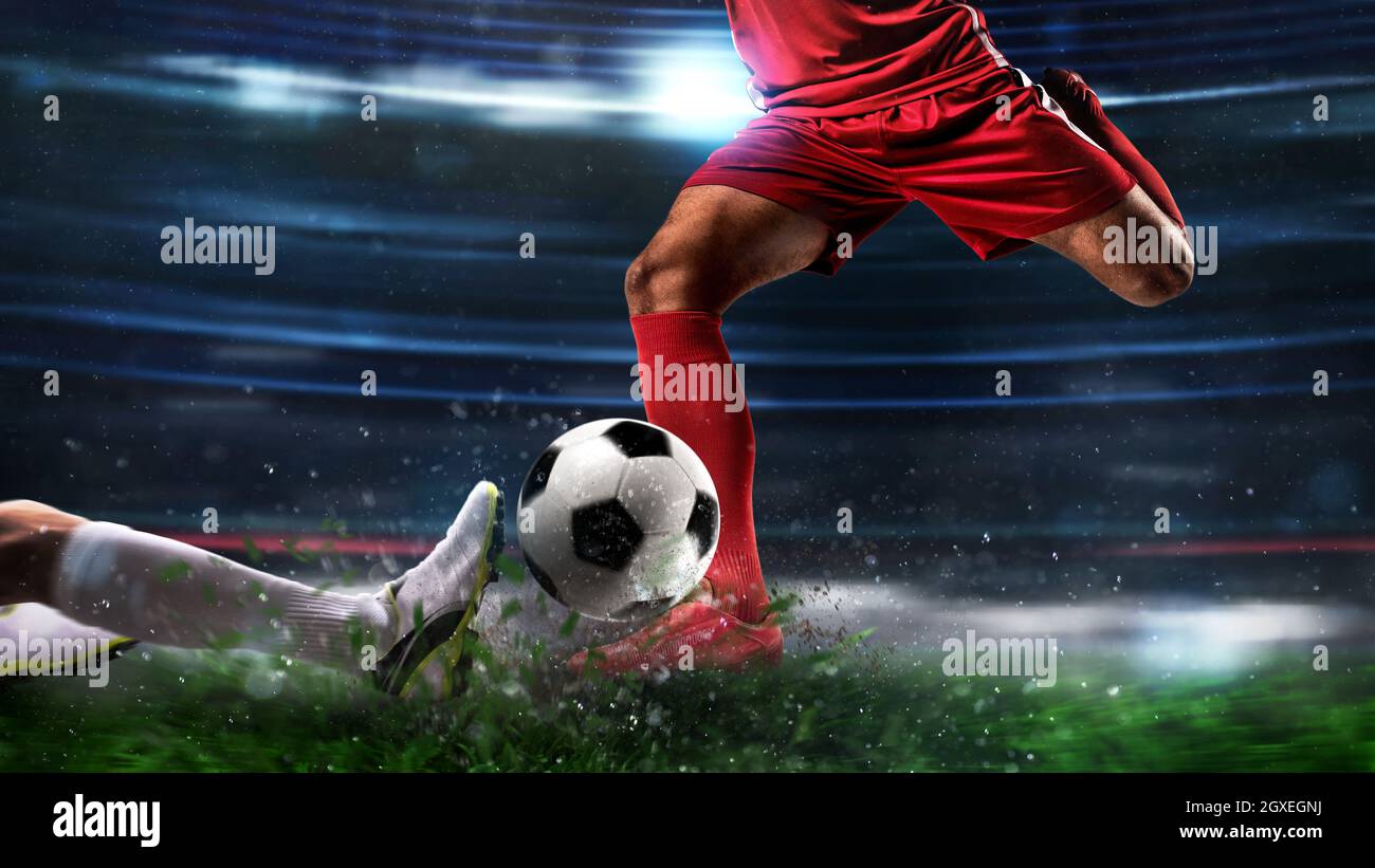 Two soccer players chase the ball at the stadium Stock Photo - Alamy