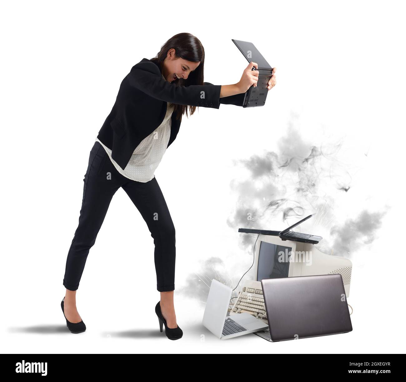 Stressed businesswoman furiously attacking computers and laptops Stock ...