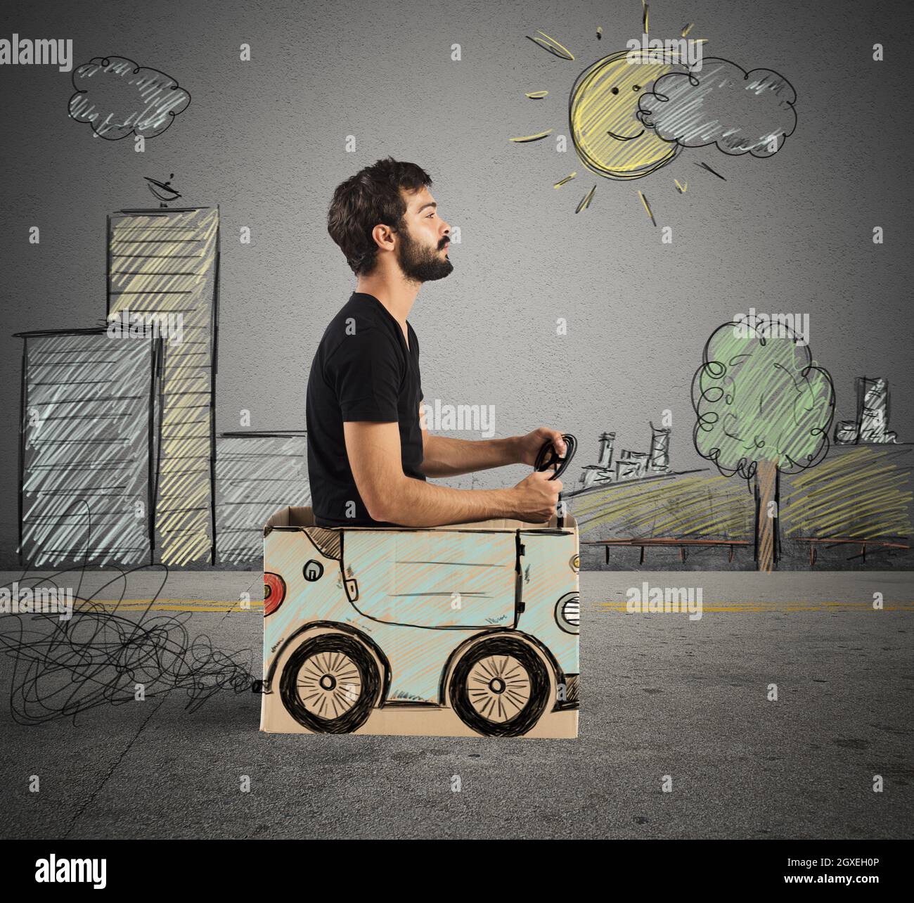 Boy driving cardboard car in drawing city Stock Photo - Alamy