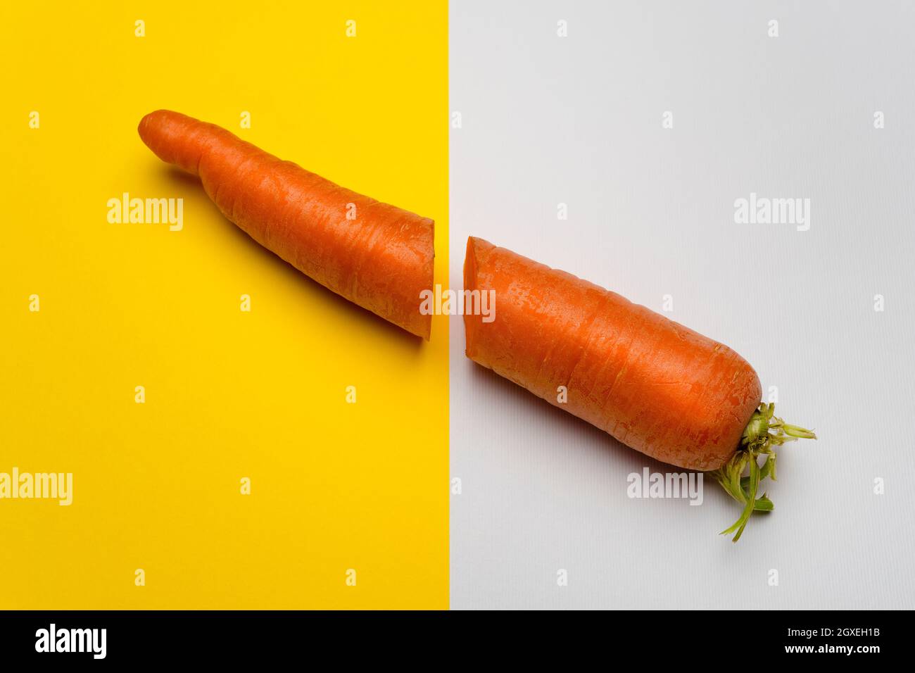 the carrot cut in half on a colored surface Stock Photo - Alamy