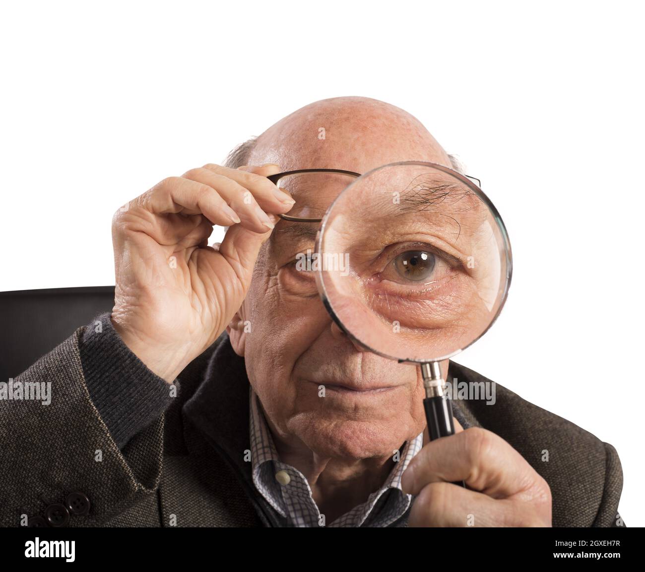 Elder magnifies and tries with magnifying glass Stock Photo - Alamy