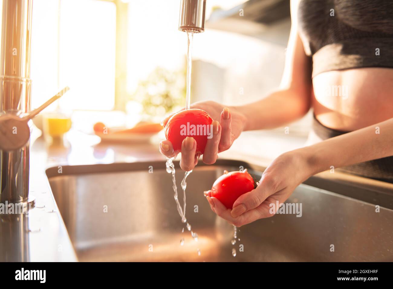 Woman in the kitchen prepare the meal washing the vegetables Stock ...