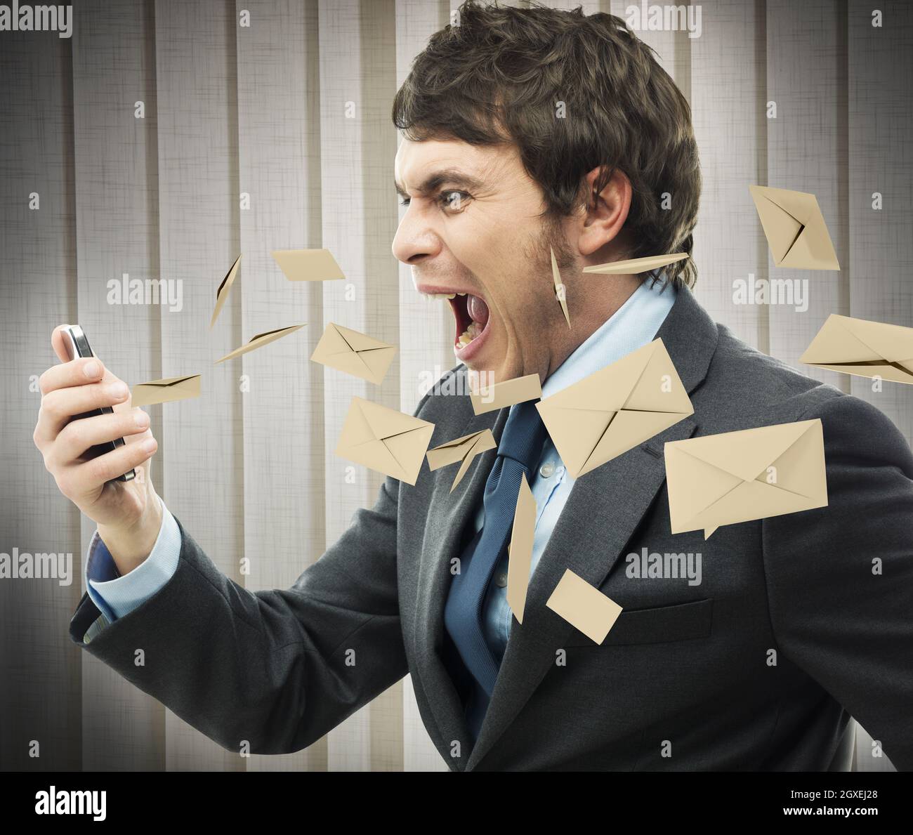 Businessman yelling for too many email received Stock Photo - Alamy