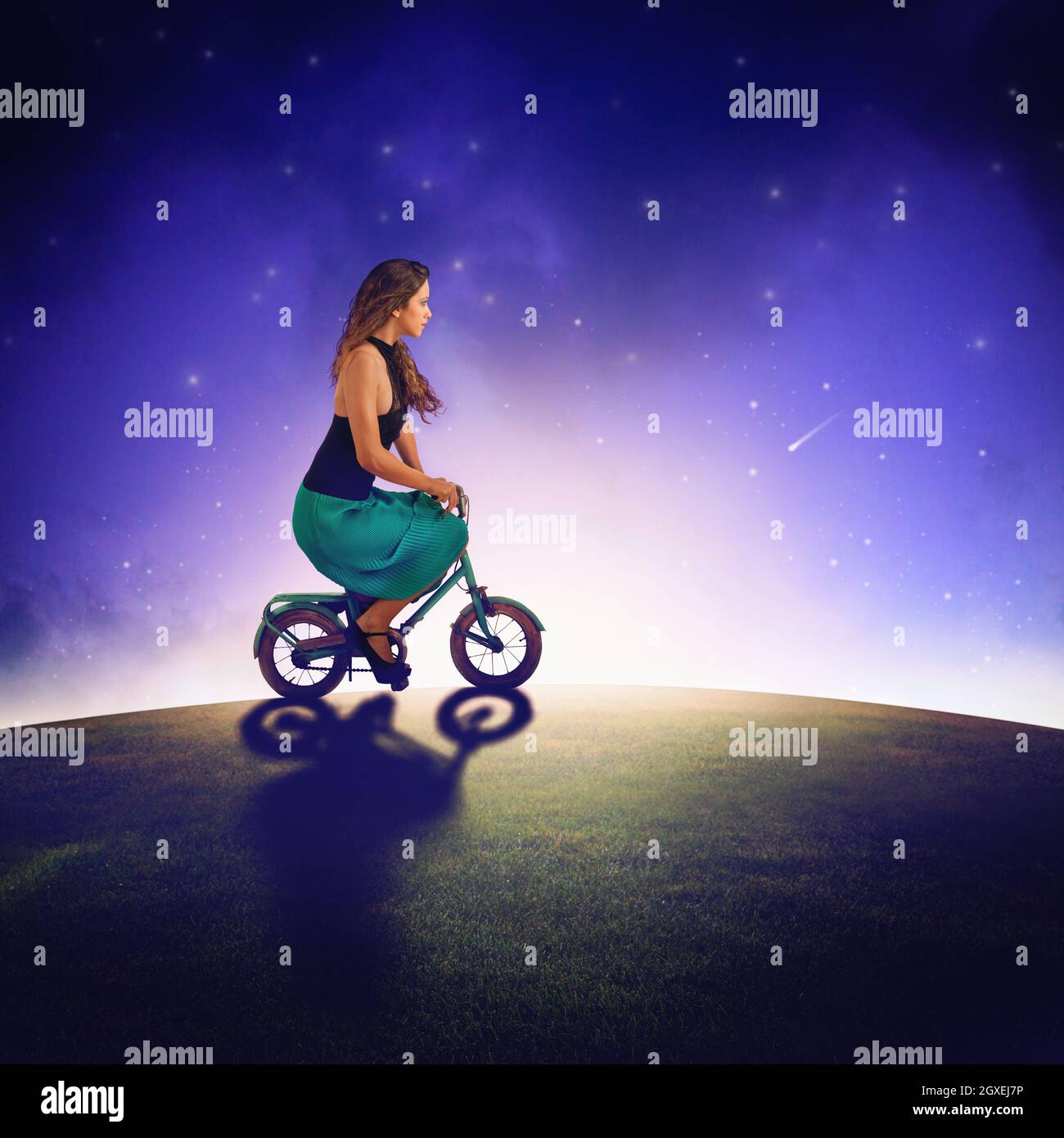 Girl with bike ride under the stars Stock Photo - Alamy