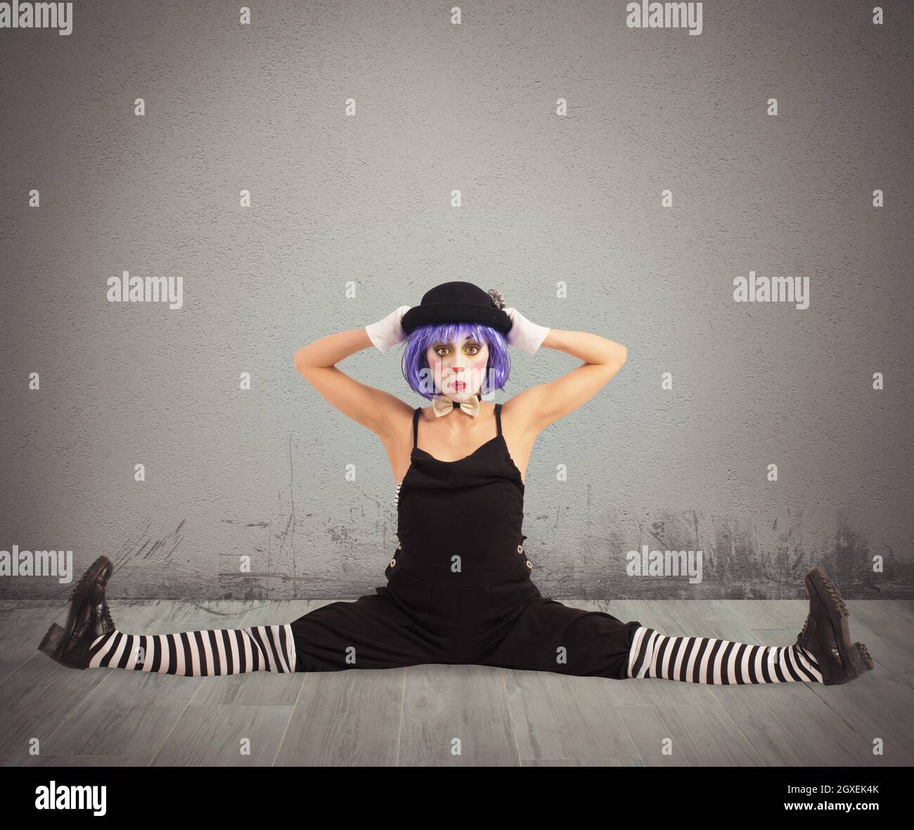 Funny clown dancer makes a big split Stock Photo - Alamy