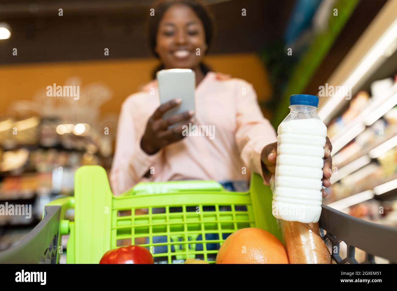 African American Customer Lady Using Phone Buying Milk In Supermarket ...
