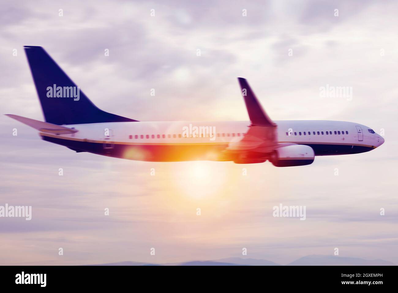 Fast aircraft flight over the clouds during sunrise Stock Photo - Alamy