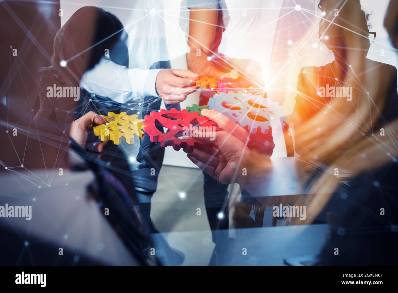 Teamwork of businesspeople work together and combine pieces of gears ...