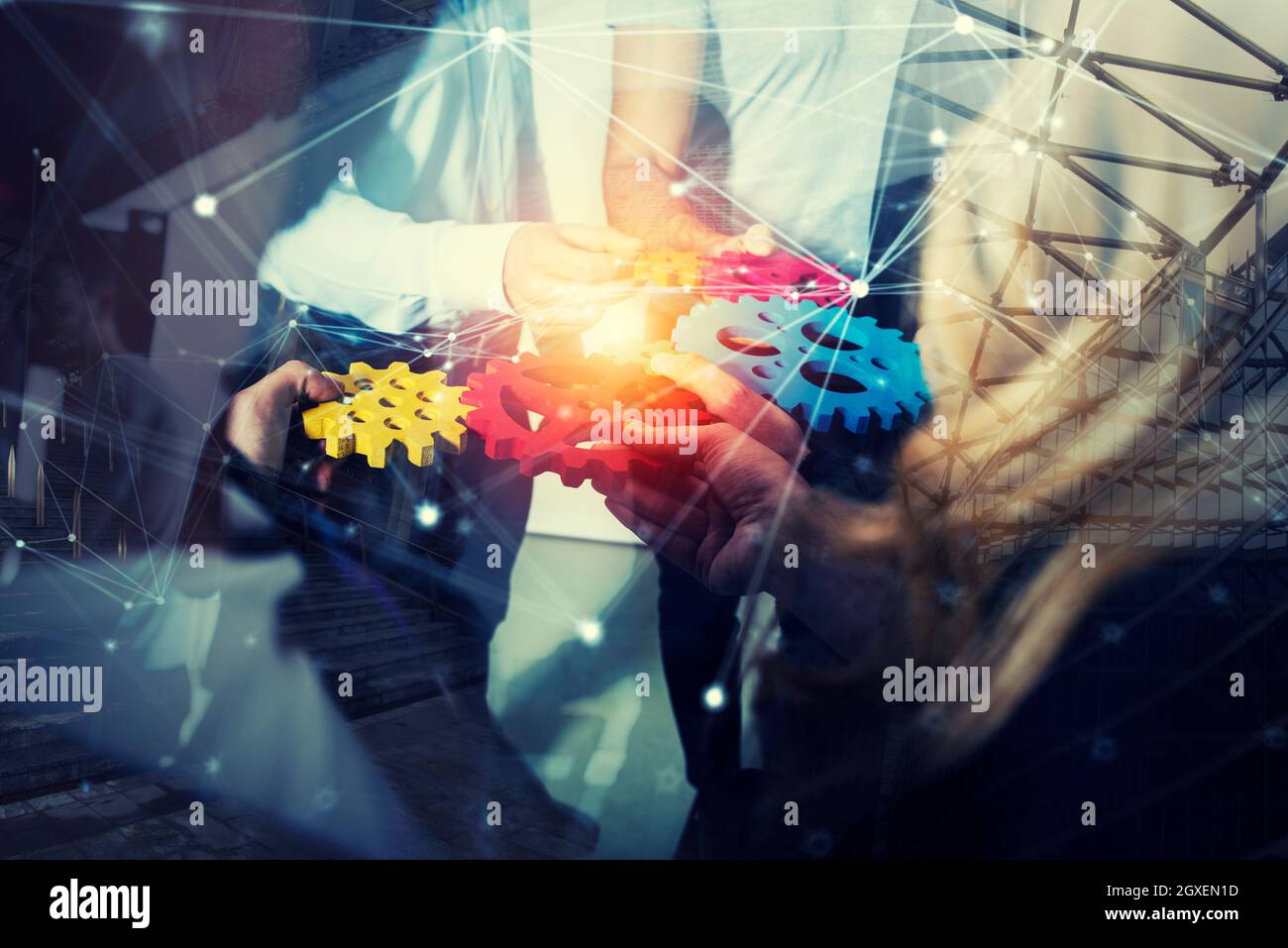 Teamwork of businesspeople work together and combine pieces of gears ...